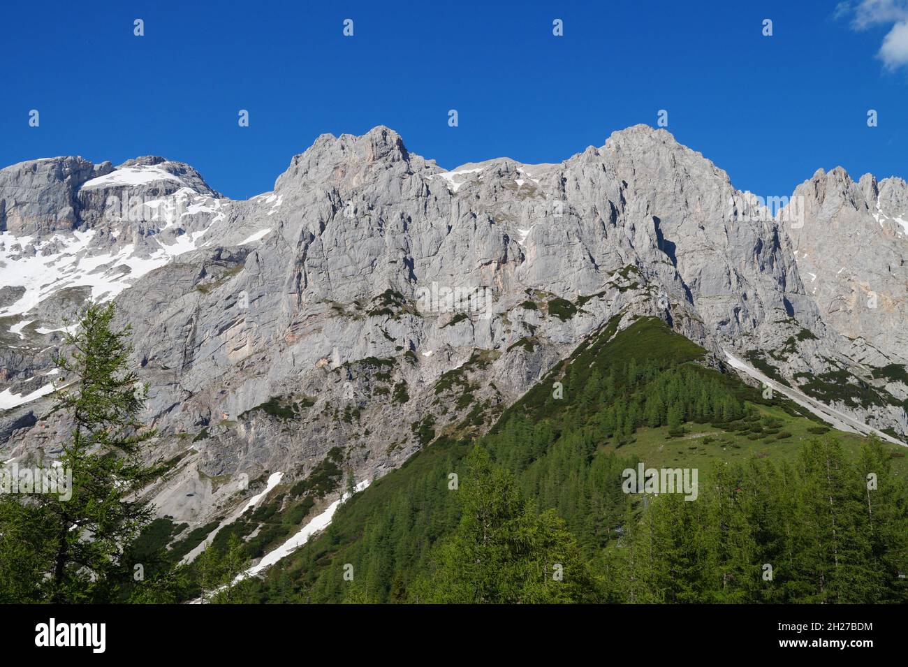 beautiful snowy Dachstein mountain against the blue sky in Steiermark ...