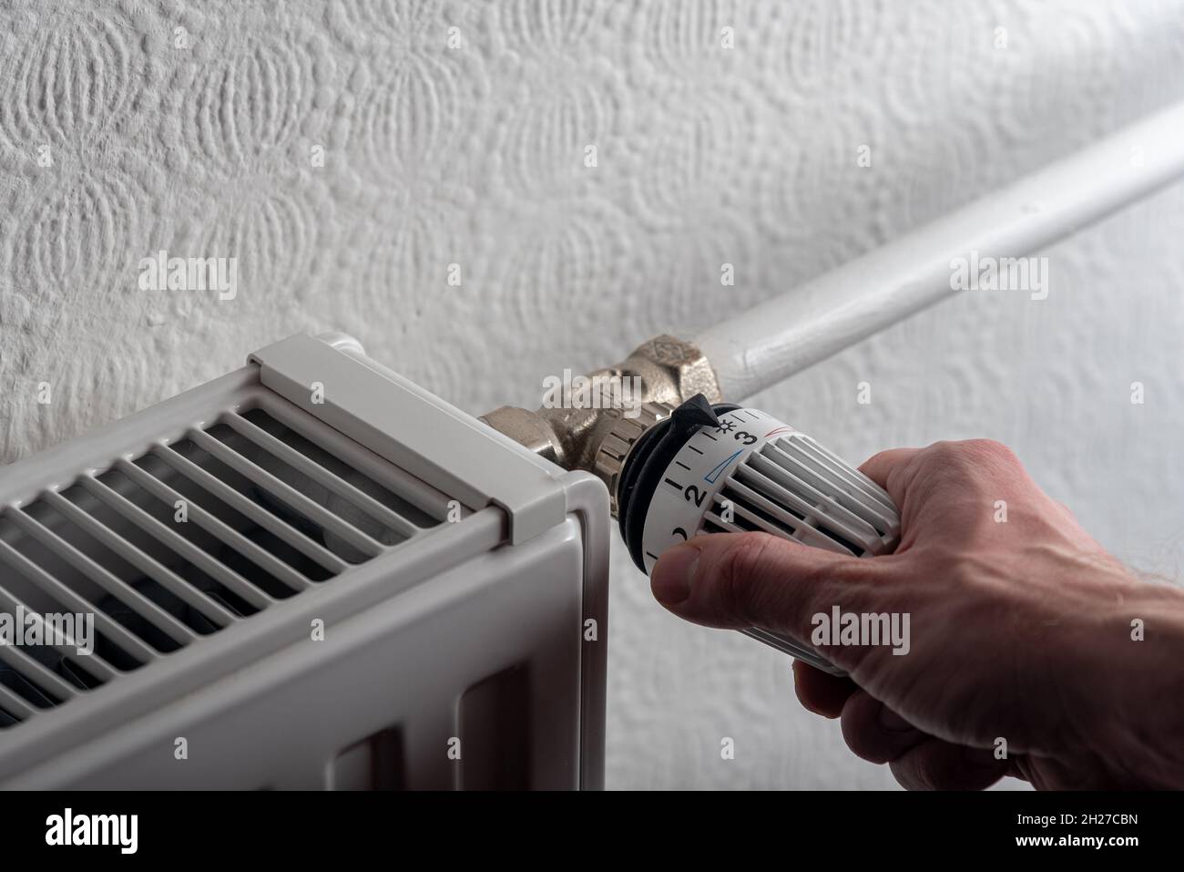 male hand adjusting knob of heating radiator Stock Photo - Alamy