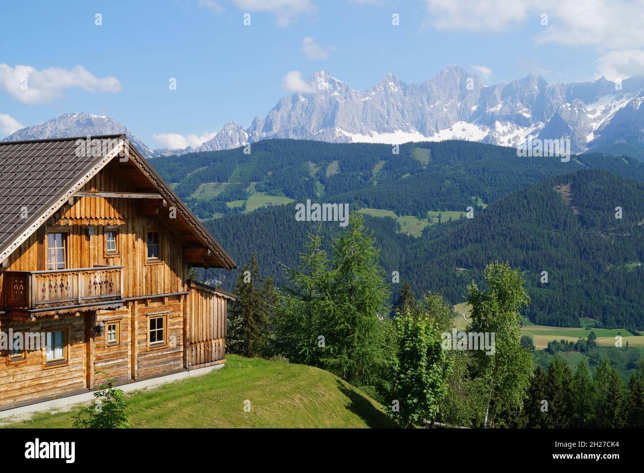 beautiful alpine panorama with a wooden cabin and the Alps of the ...