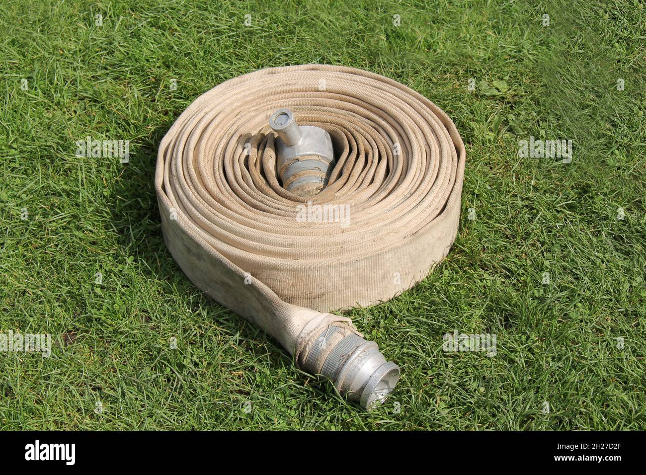 A Vintage Cloth Made Coiled Fire Hose Stock Photo - Alamy