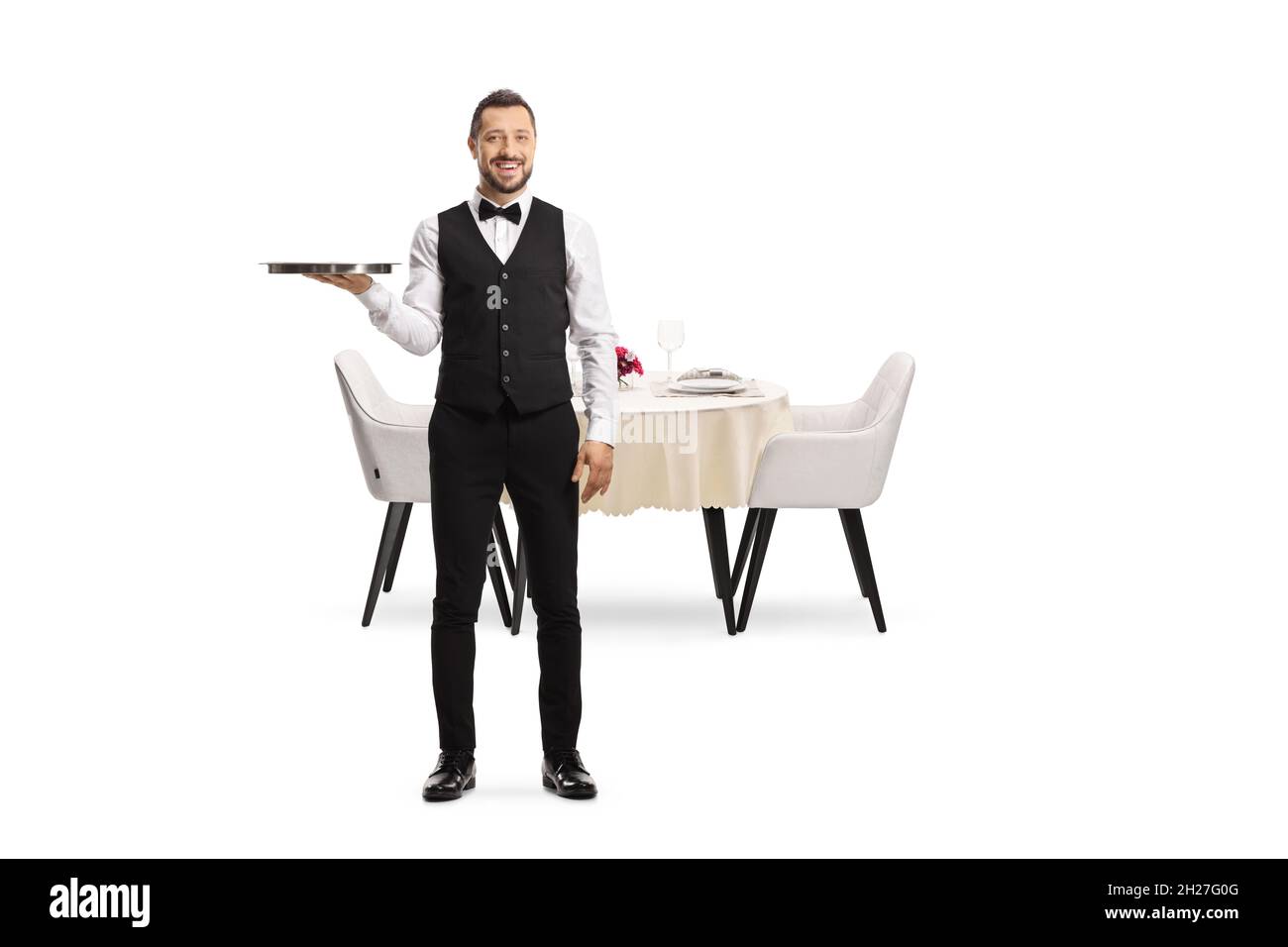 Full length portrait of a server with a silver tray standing in front ...