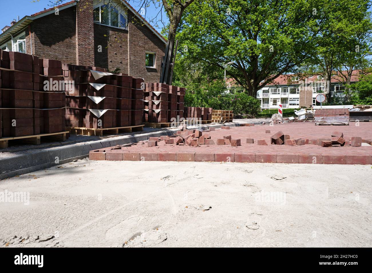 Construction of a cobblestone street. Pile of cobblestones with sand ...