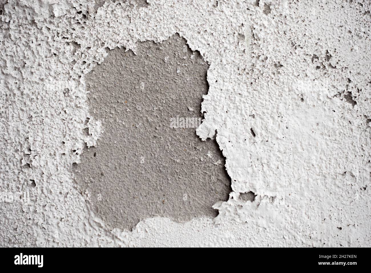 White damp wall showing paint cracking open and breaking or peeling off ...