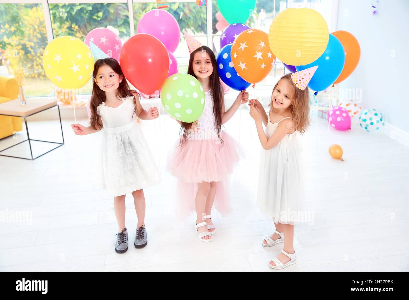 Cute girls with balloons at birthday party indoors Stock Photo - Alamy