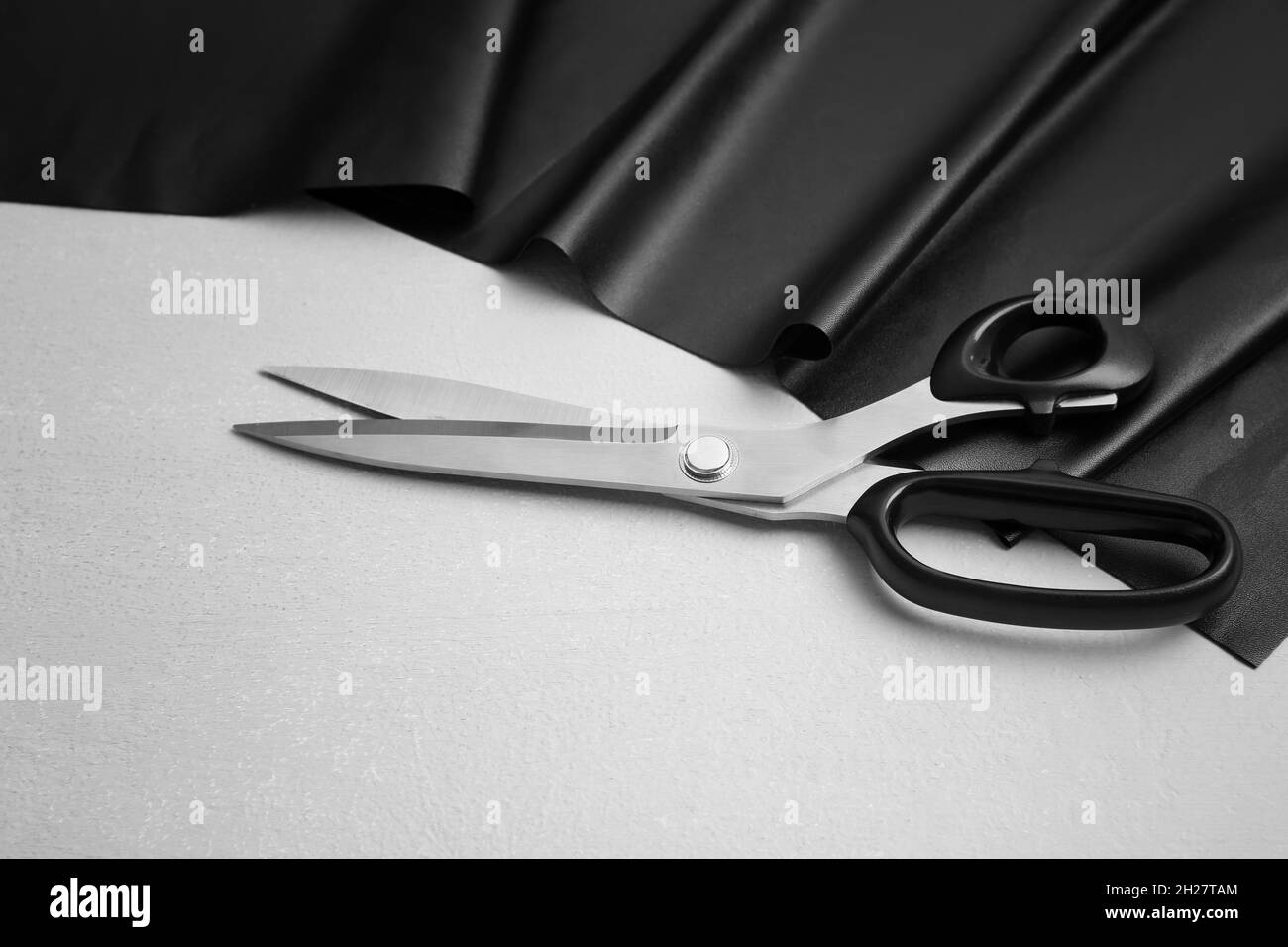 Scissors and fabric on grey background. Tailoring items Stock Photo - Alamy