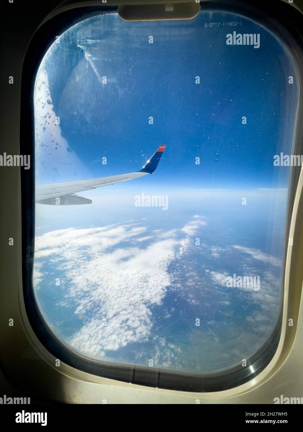 the wing of an airplane photographed from the window during the flight ...