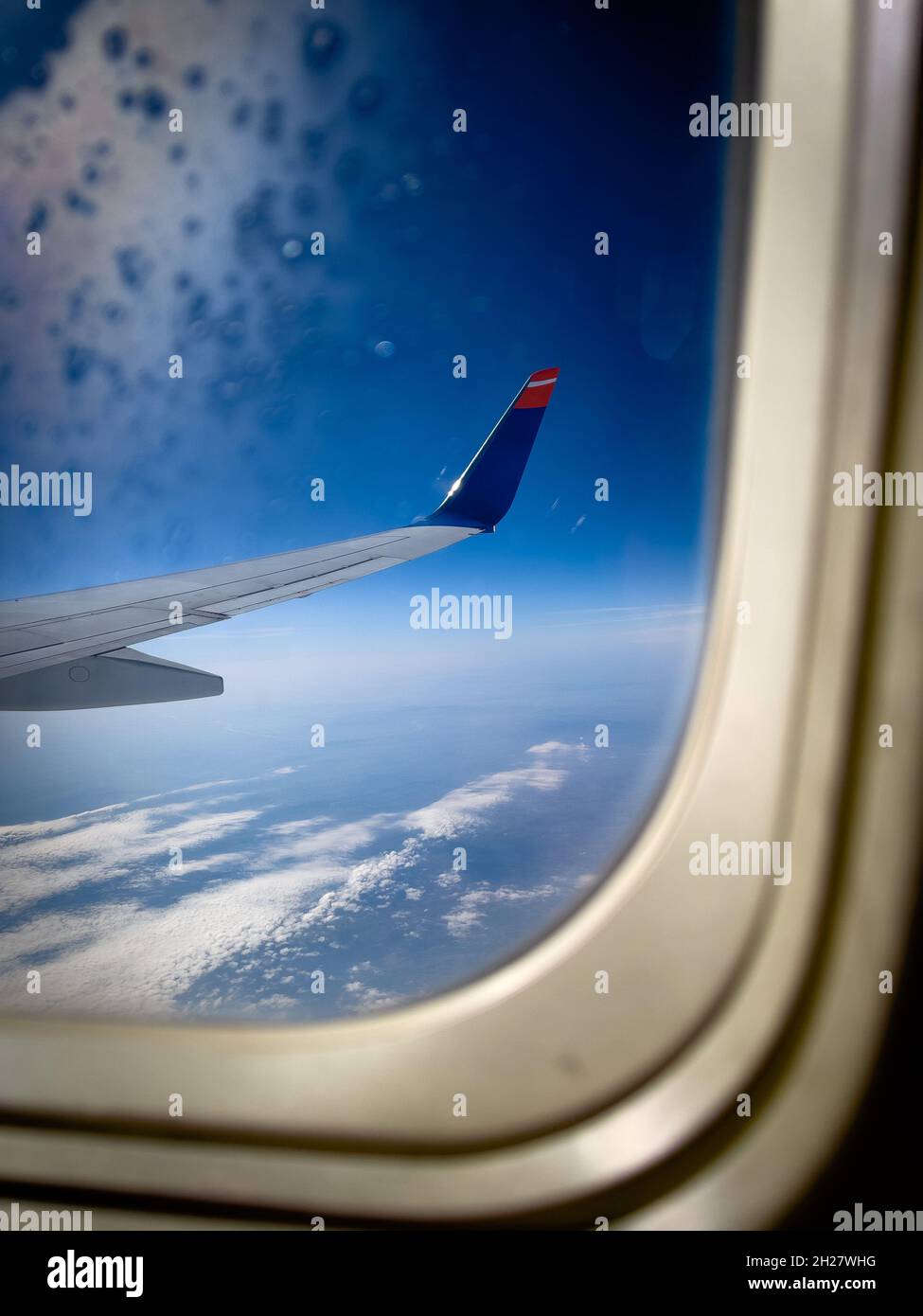 the wing of an airplane photographed from the window during the flight ...