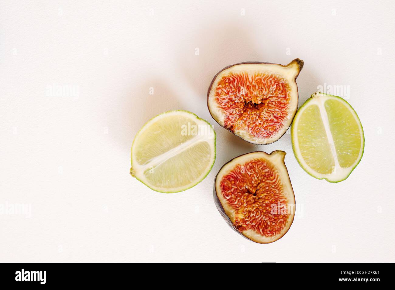 Lime and figs isolated on white background. Fresh natural looking ...