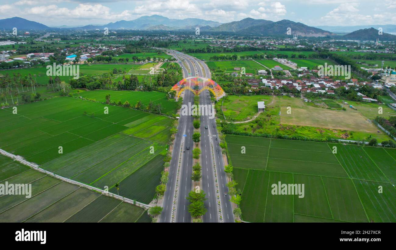 Aerial view of the city colorful Monument Tembolak Rainbow on Mataram ...
