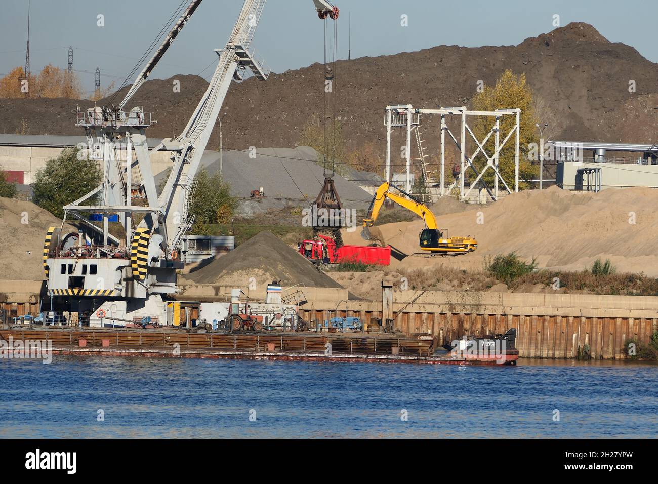Construction site on the river bank. Extraction and transportation of ...