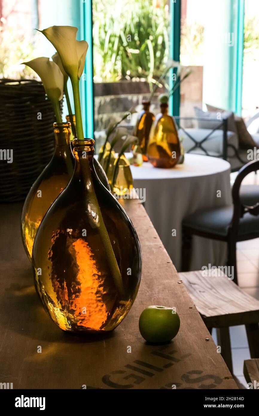 Interior of a restaurant with tables decorated with flowers in glass ...