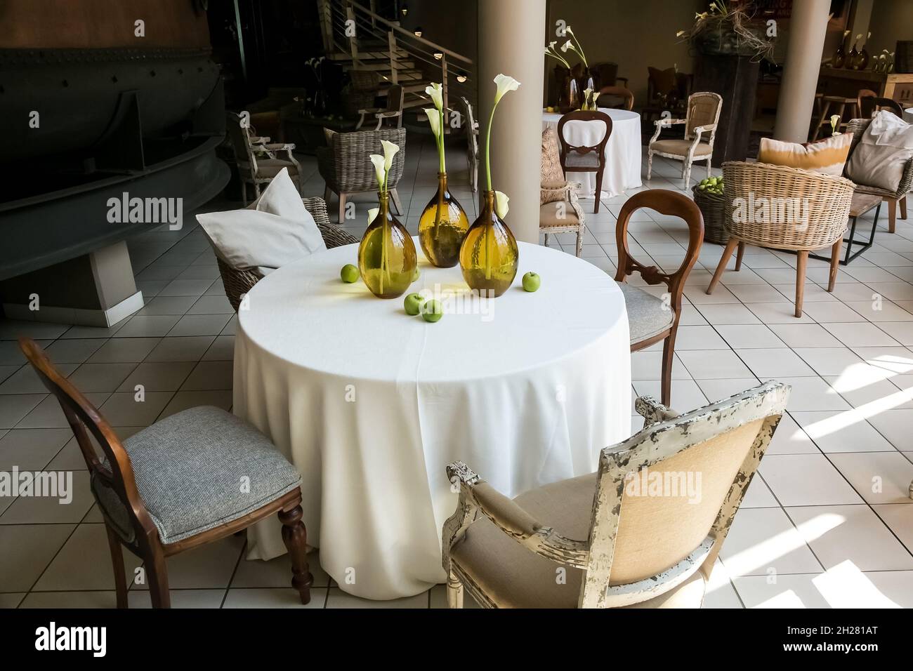 Interior of a restaurant with tables decorated with flowers in glass ...