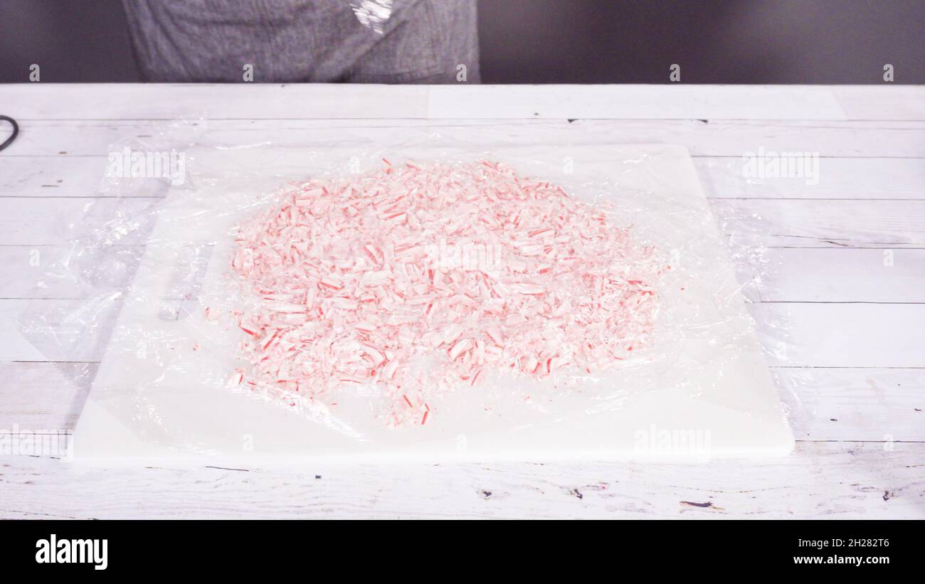 Step by step. Breaking candy cane candies into small pieces Stock Photo ...