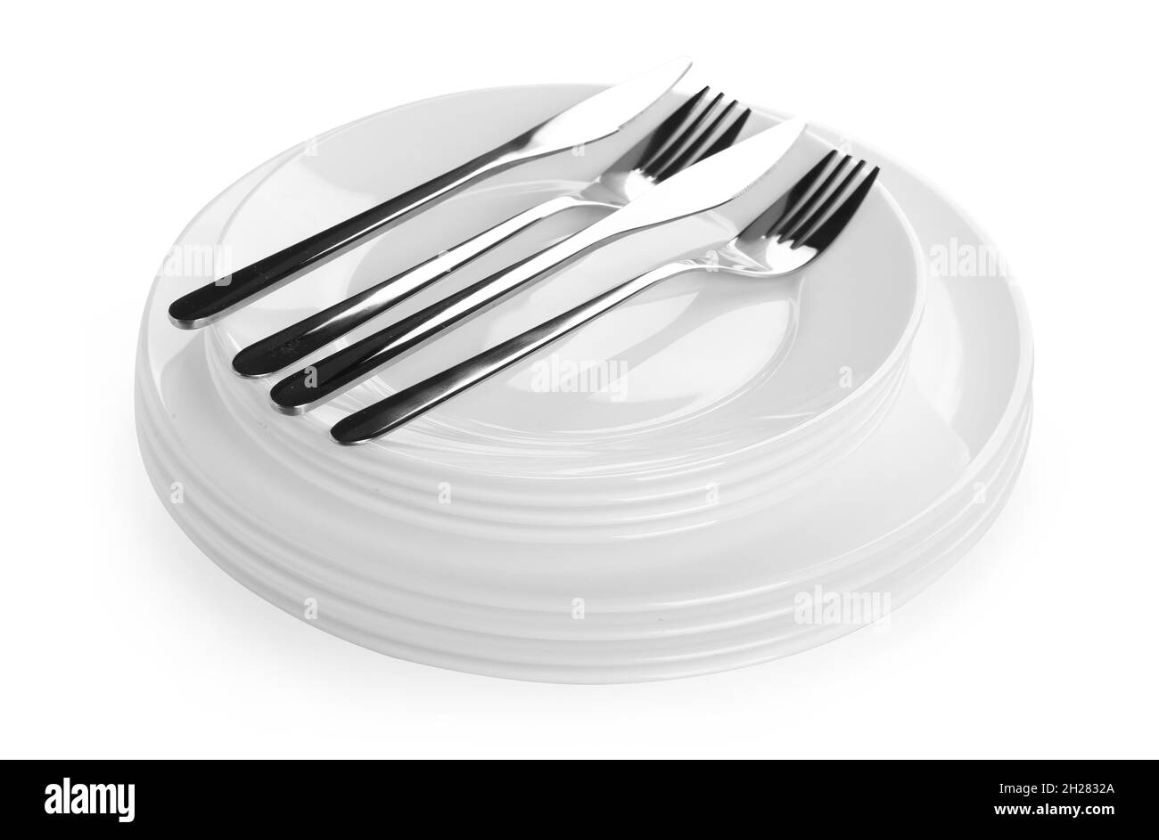 Stack of plates with forks and knife on white background Stock Photo ...