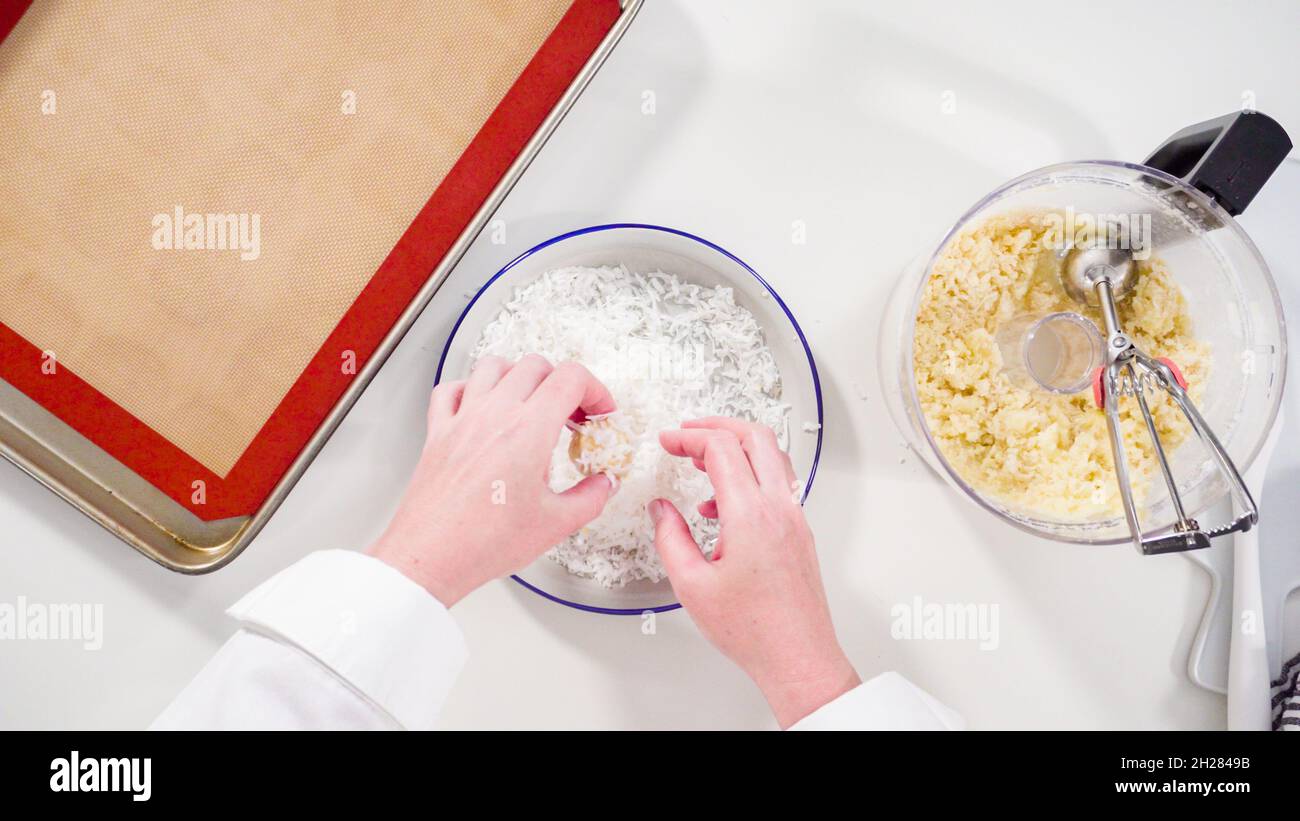 Flat lay. Scooping cookie dough into the baking sheet to bake coconut ...