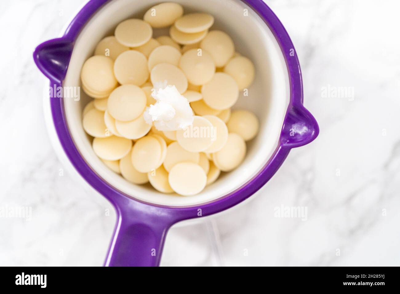 Melting chocolate melts in a candy melting pot to prepare mermaid tails ...