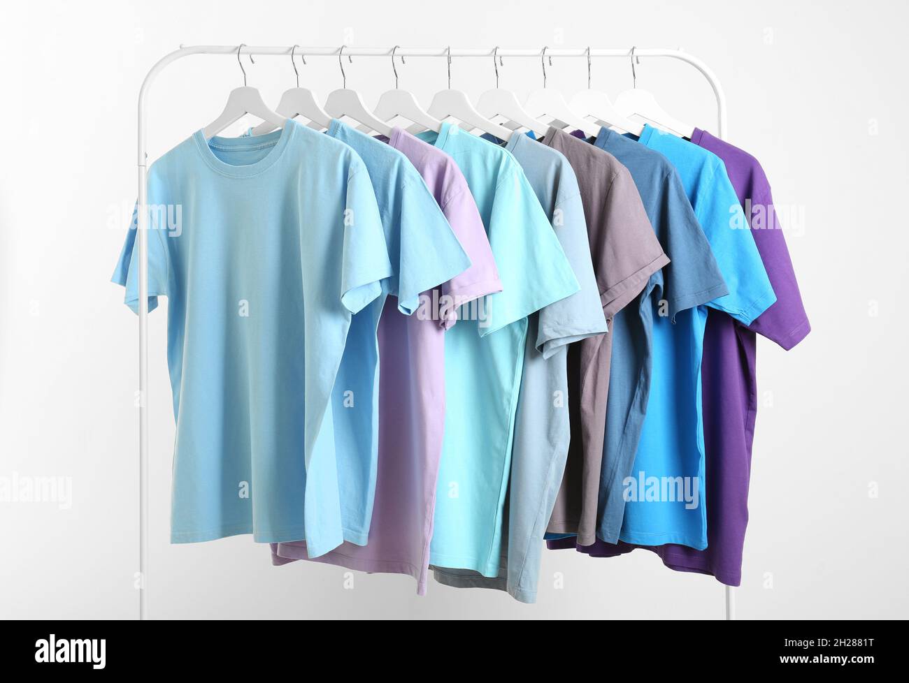 Men's clothes hanging on wardrobe rack against white background Stock ...