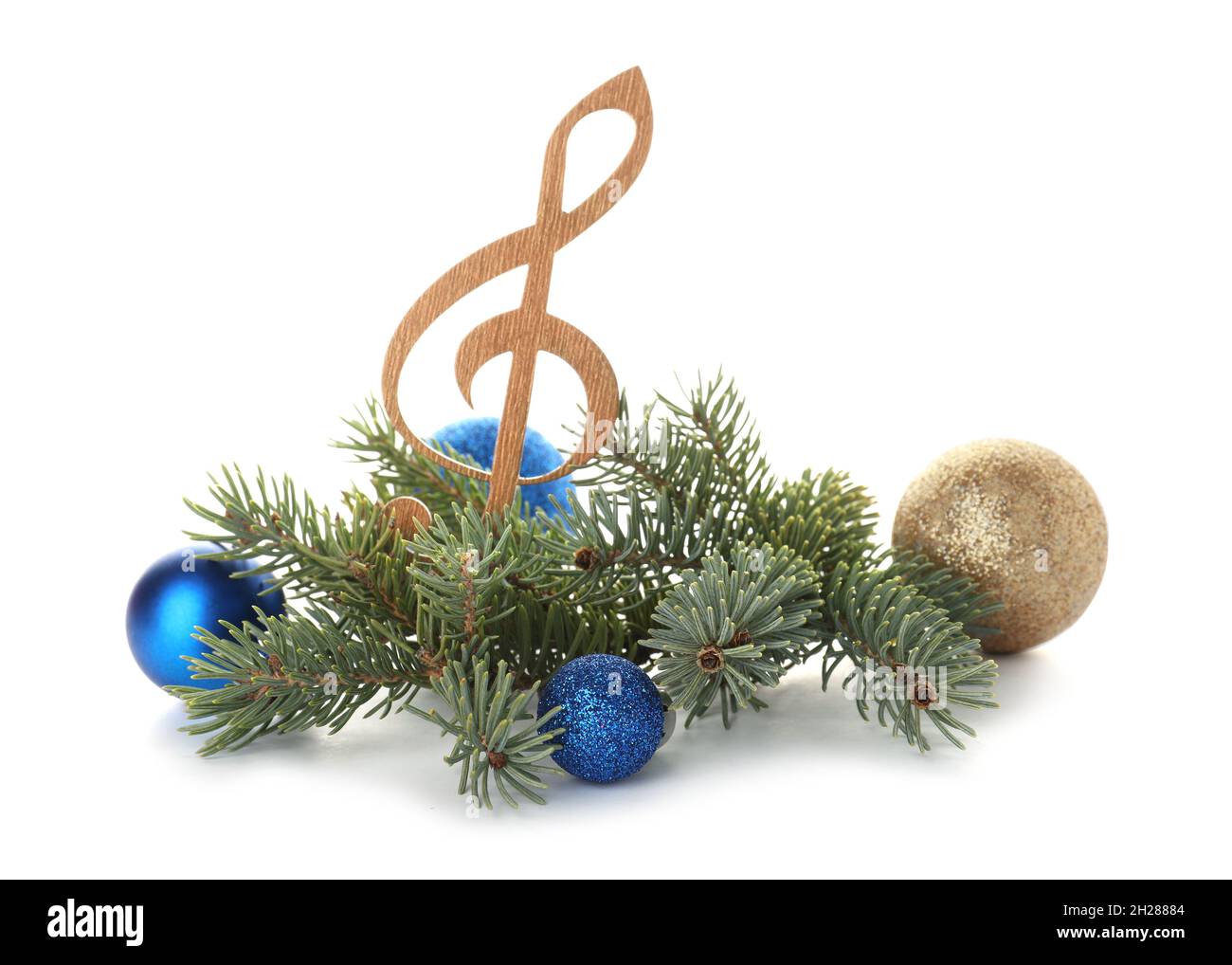 Composition with wooden treble clef, balls and fir tree branches on ...