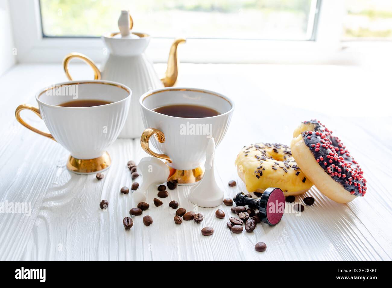 White and black chess pieces on white windowsill. Morning coffee of a ...