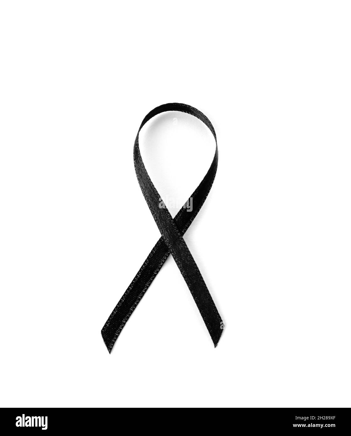 Black ribbon on white background. Funeral accessory Stock Photo - Alamy