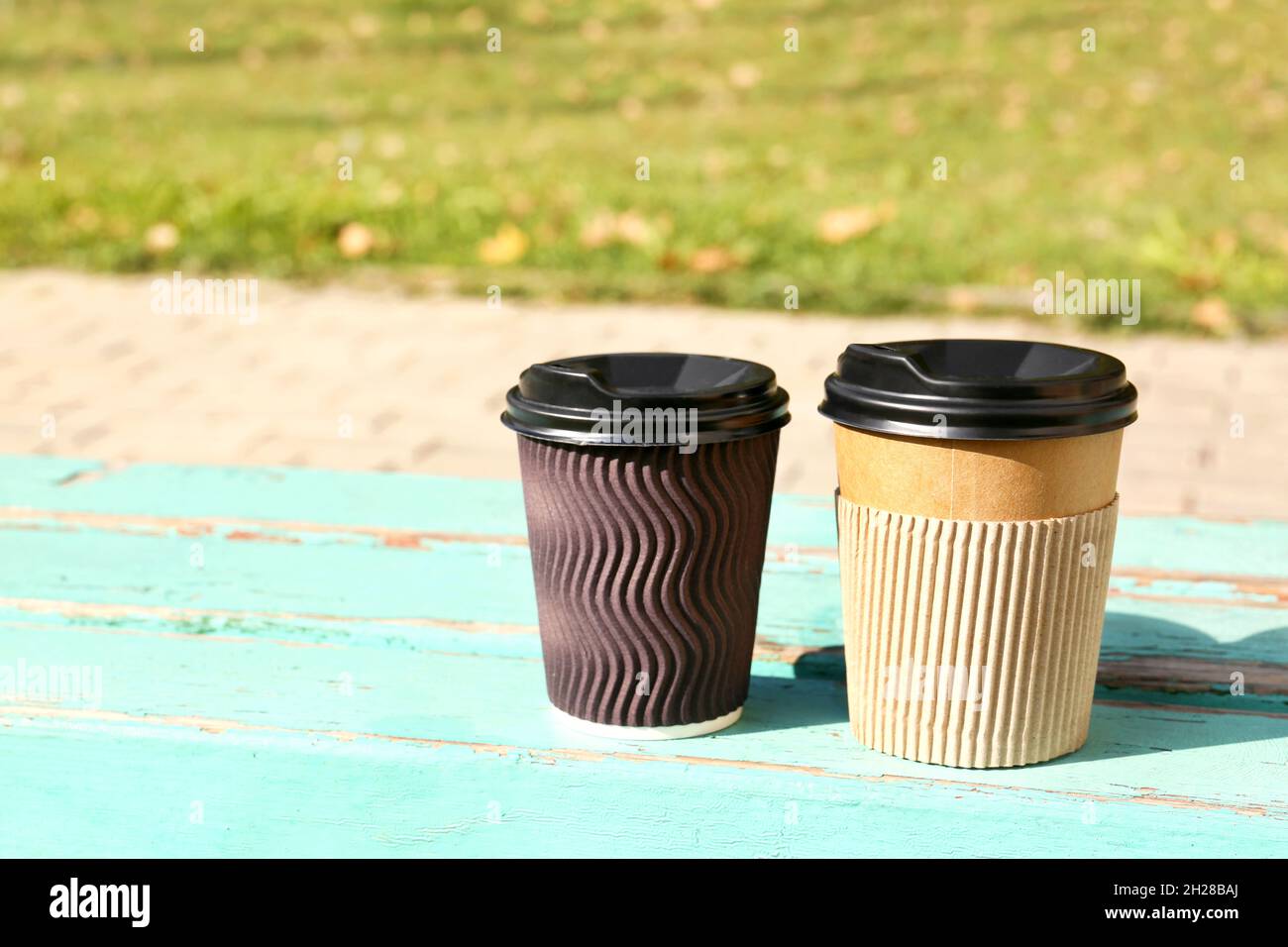 Cardboard coffee cups on wooden table outdoors. Space for design Stock ...