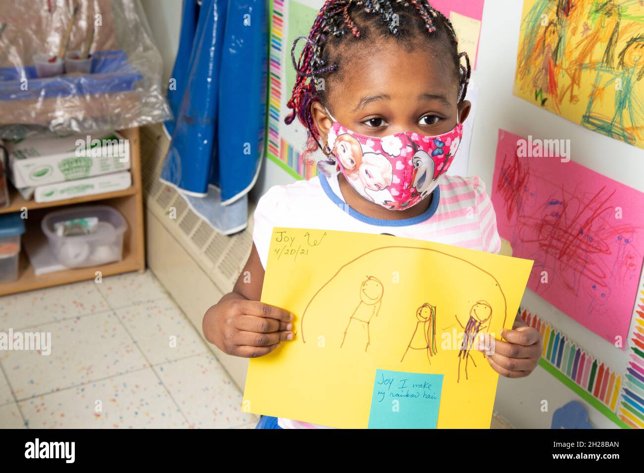 Education Preschool 4-5 year olds girl holding up drawing of her family ...