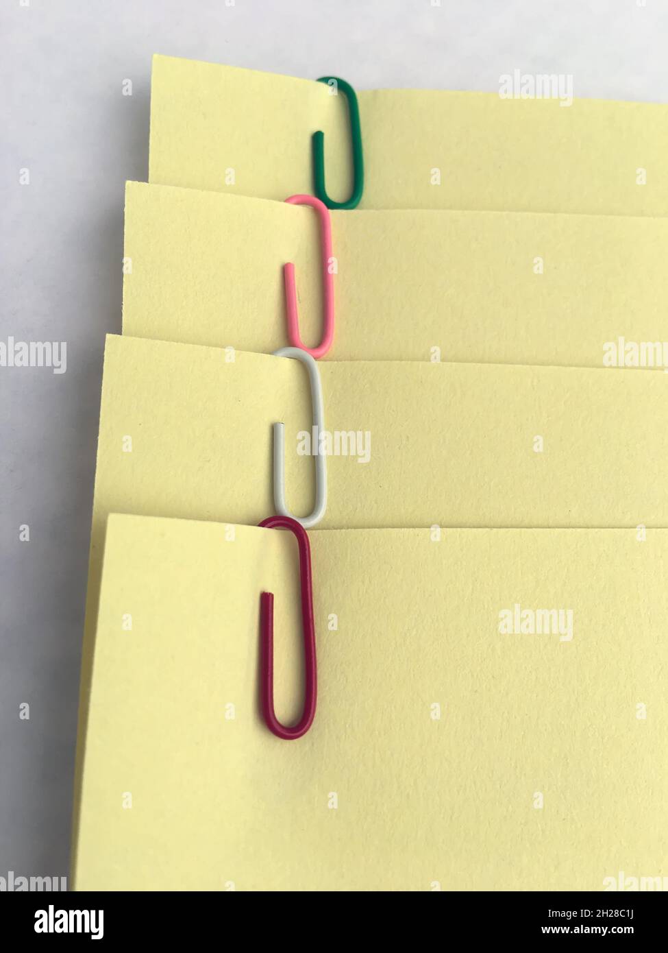 Yellow paper notes binden with staples. Notes and staples Stock Photo ...