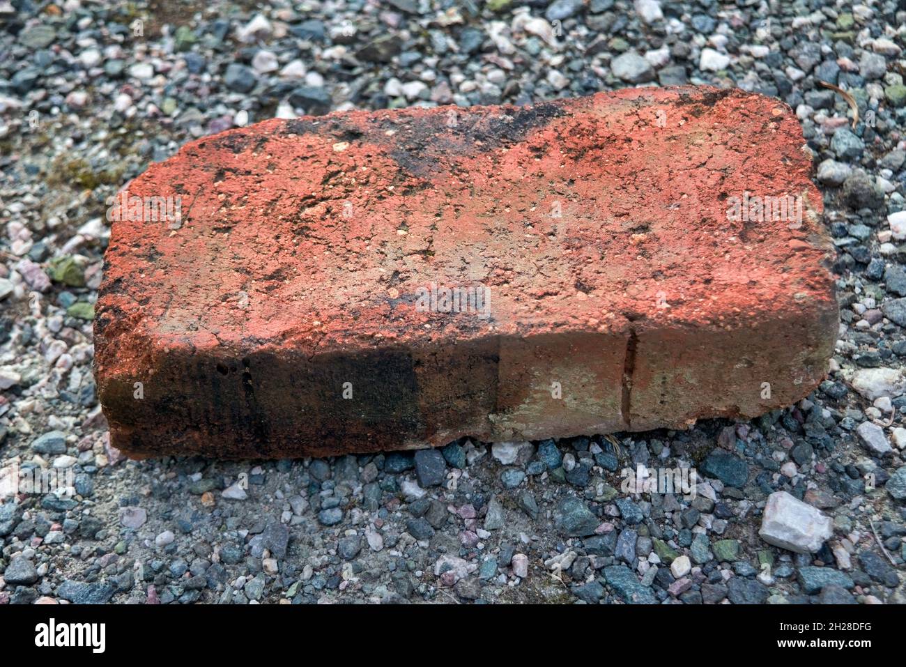 Close-up of an old rweathered red brick lying on the ground Stock Photo ...