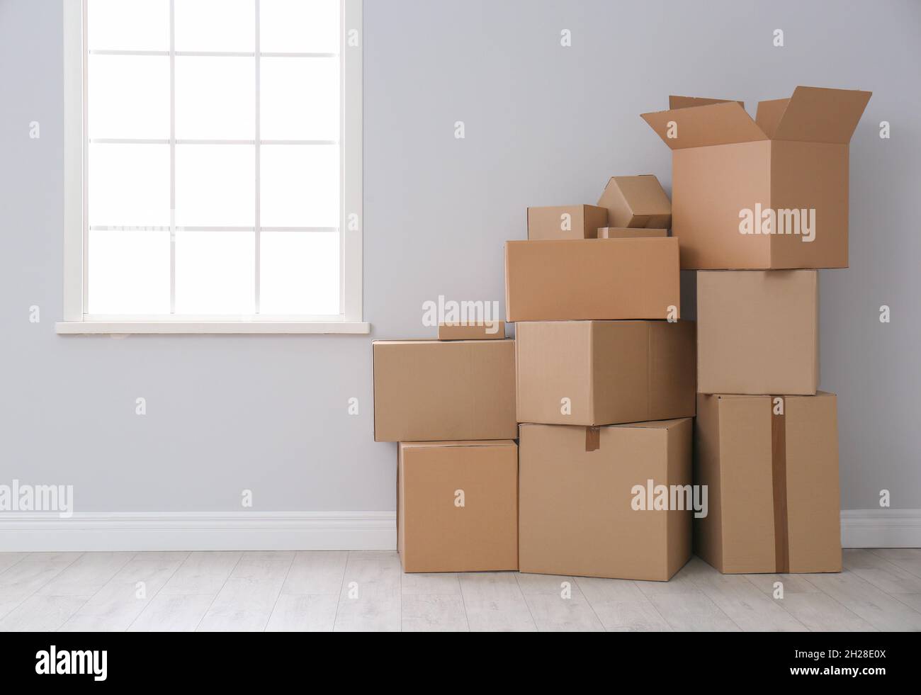 Cardboard boxes on floor indoors Stock Photo - Alamy