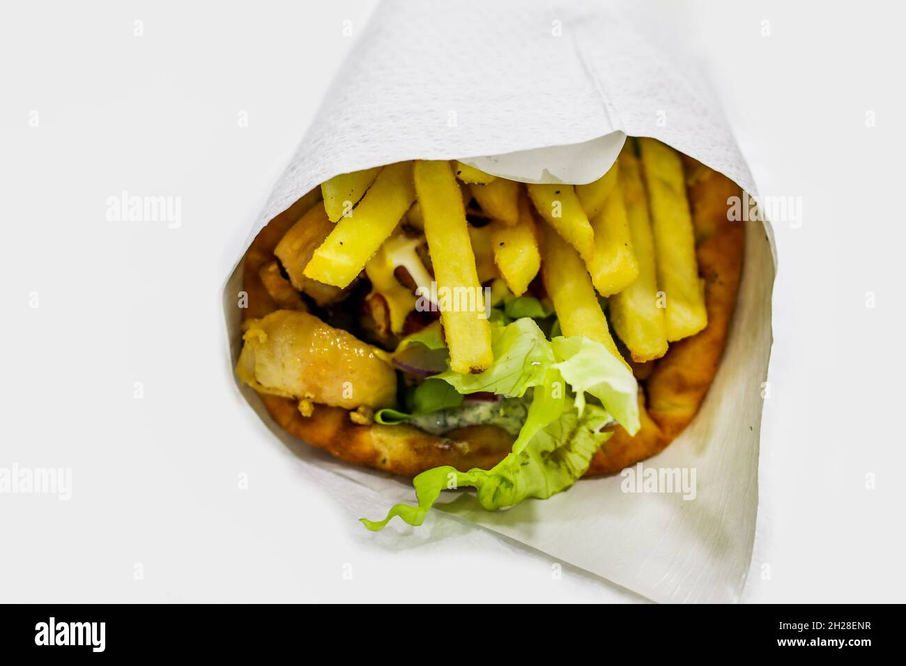 Greek gyros wrapped in pita bread isolated on white background. Fast ...