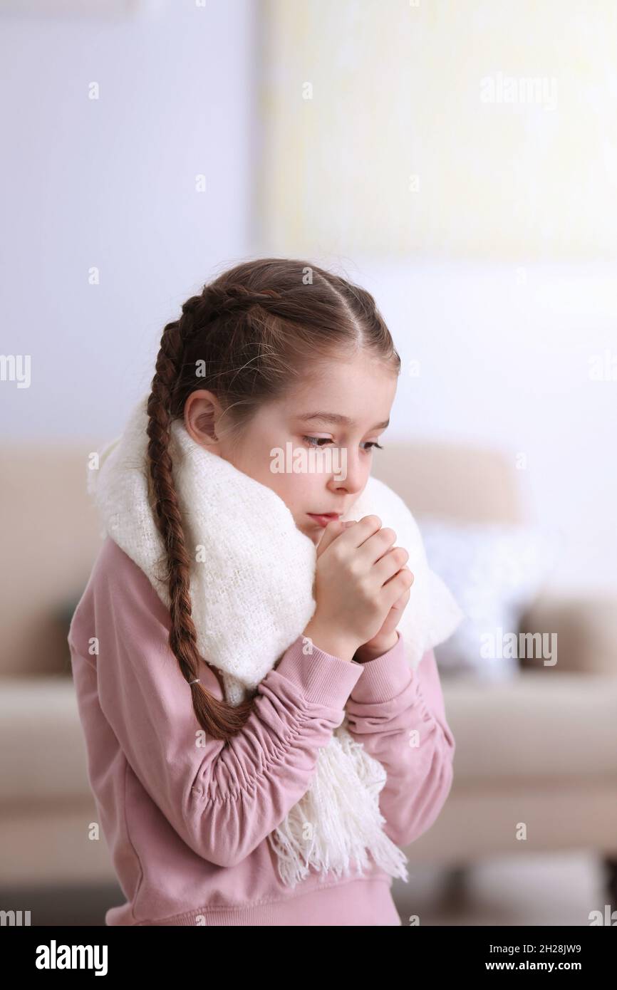 Sad little girl suffering from cold on blurred background Stock Photo ...
