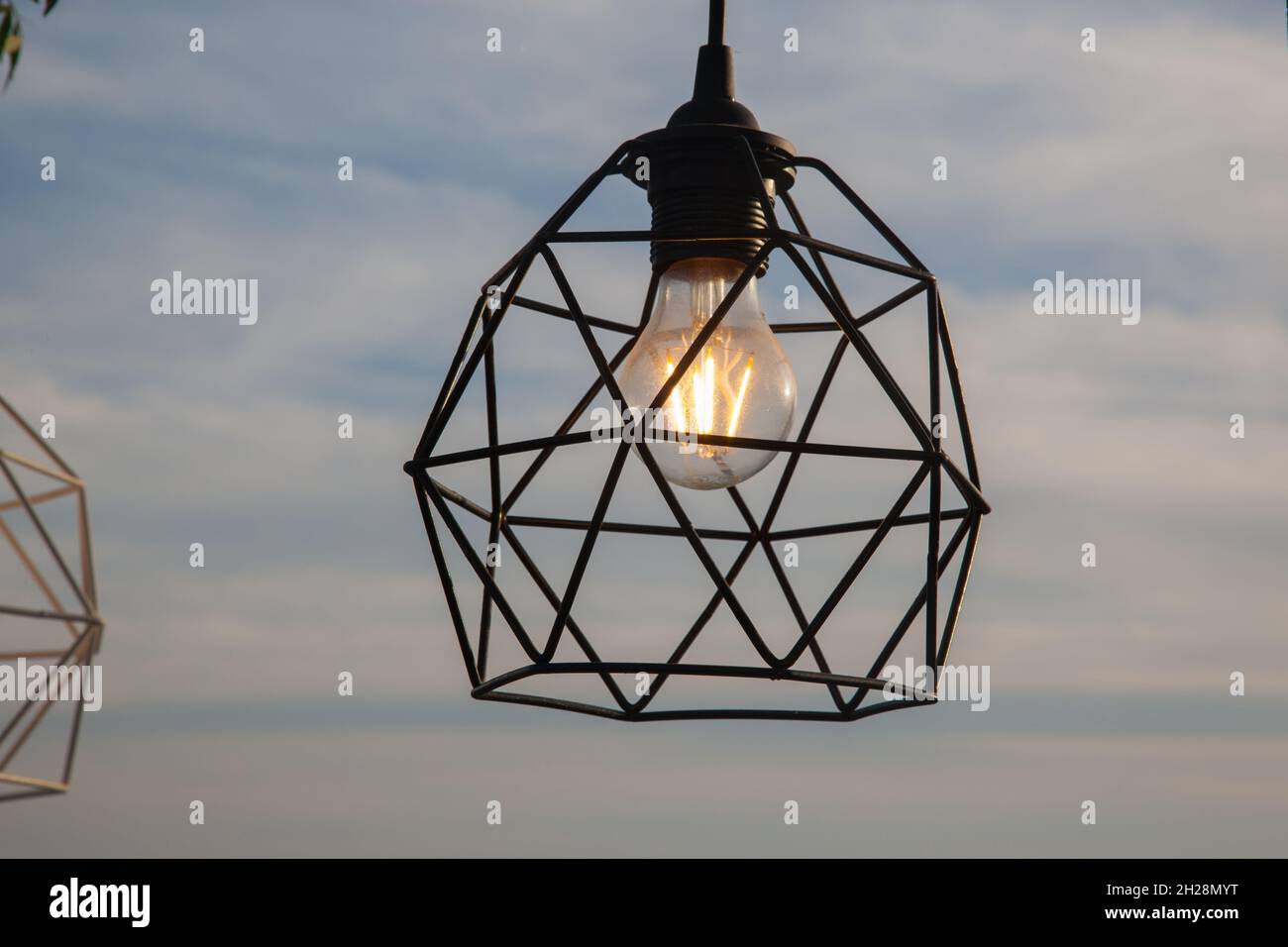 Decorative filament bulb on a terrace at dusk Stock Photo - Alamy