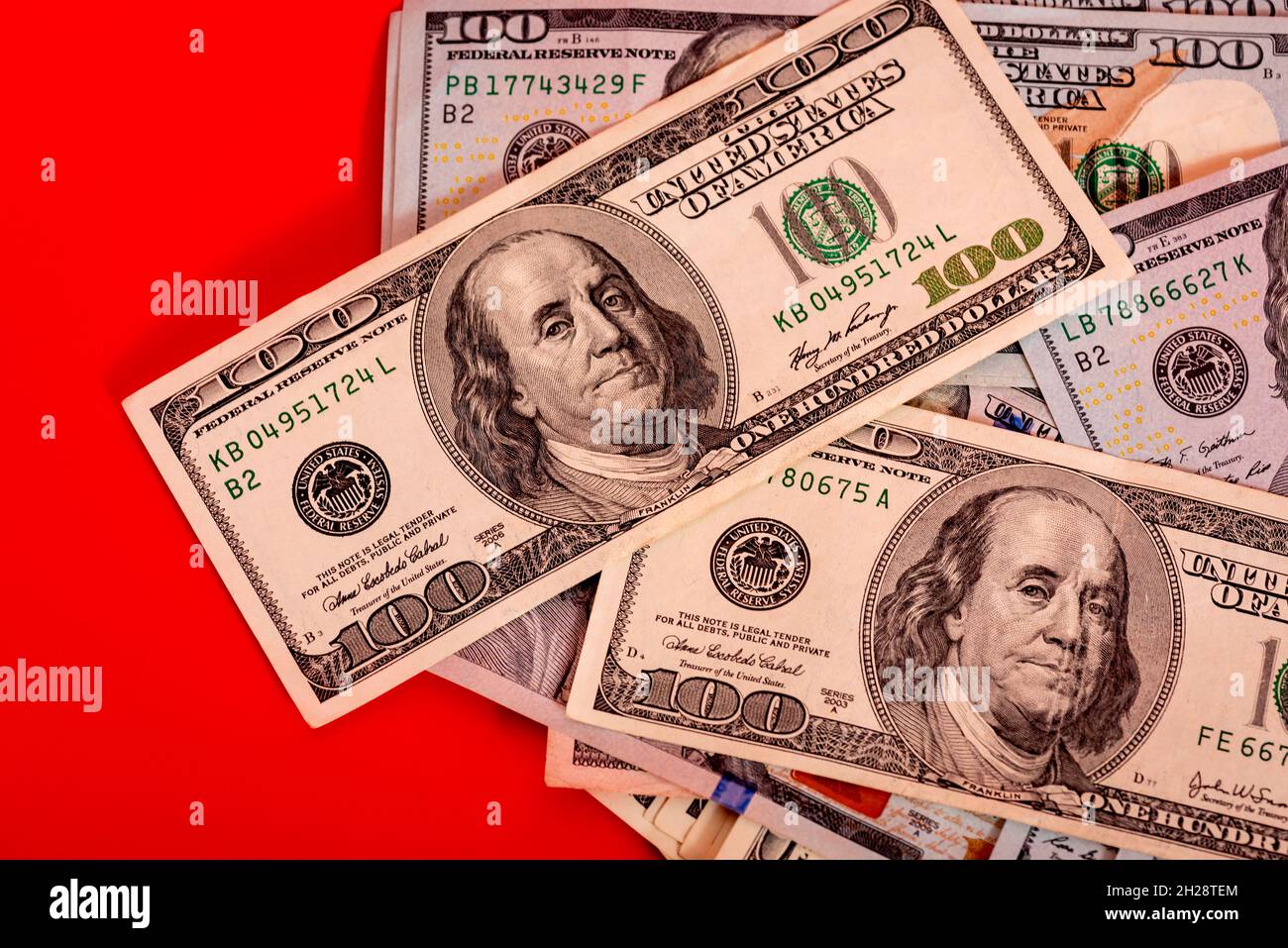 Paper banknotes dollars on a bright red background. Banking and finance ...
