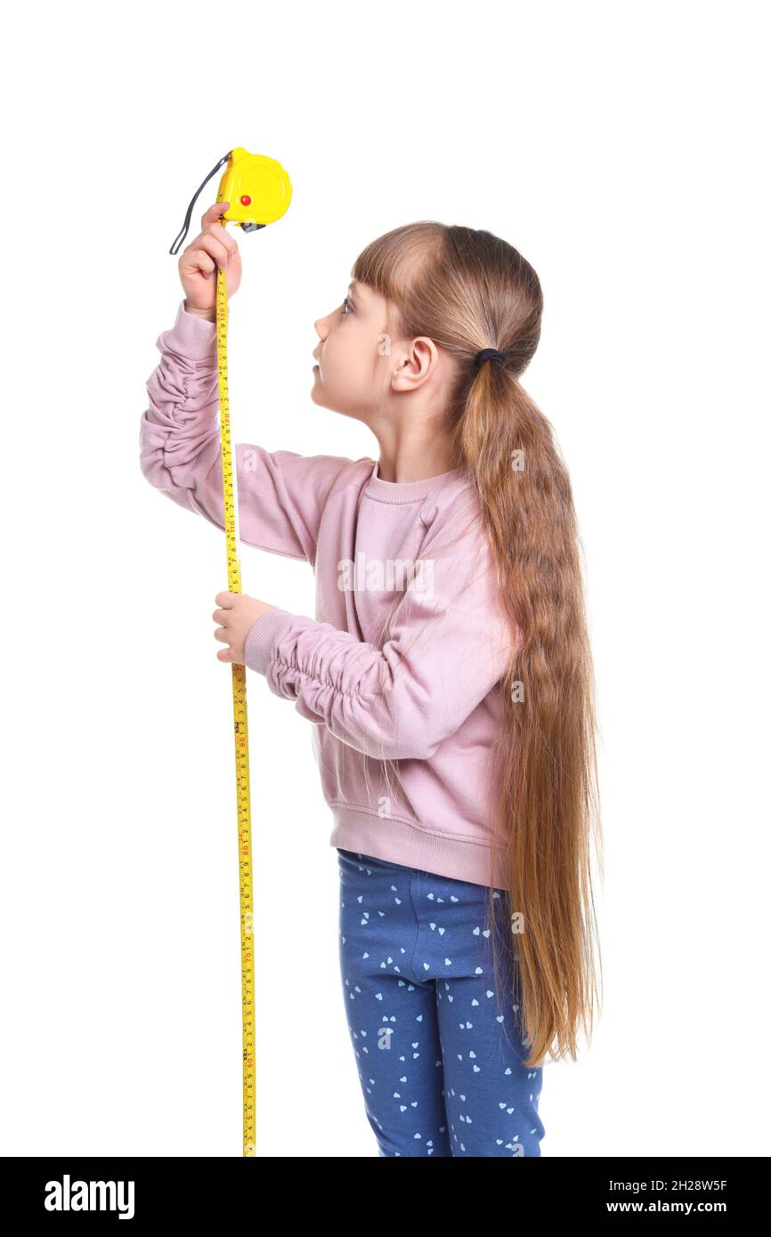 Little girl measuring her height on white background Stock Photo - Alamy