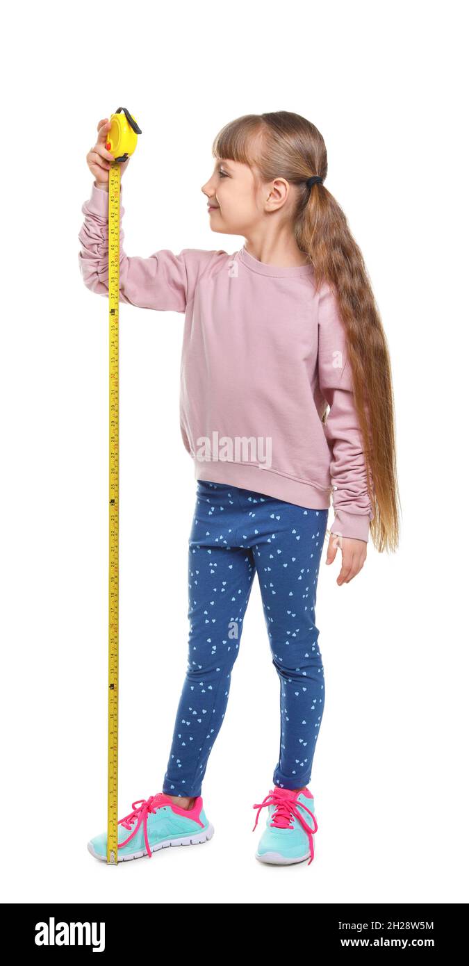 Little girl measuring her height on white background Stock Photo - Alamy
