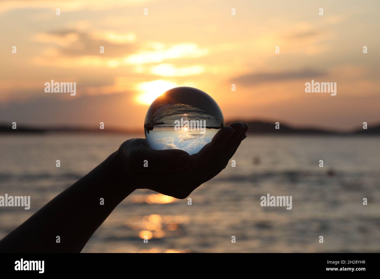 Sunset through a transparent glass ball Stock Photo - Alamy