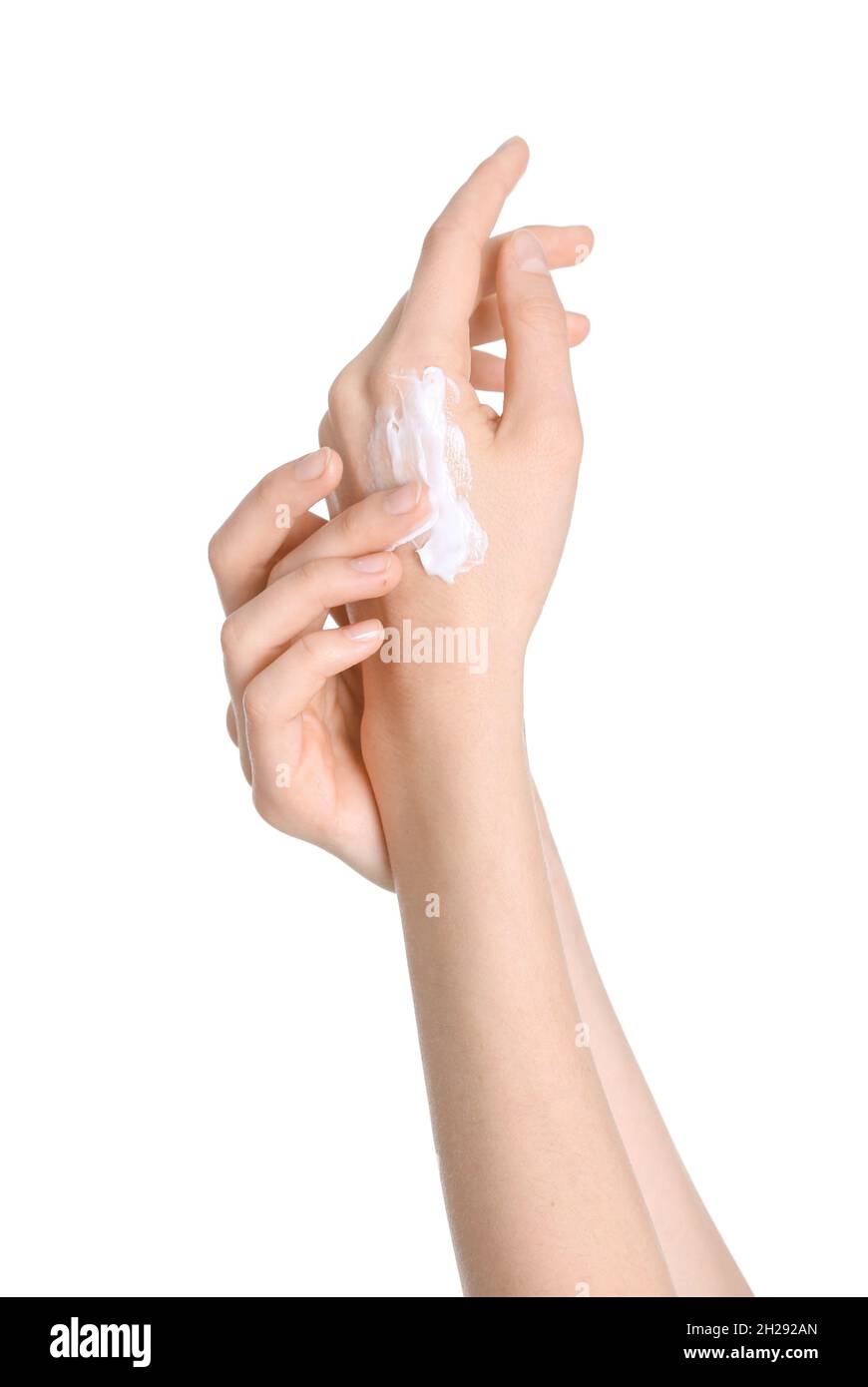 Young woman applying hand cream on white background Stock Photo - Alamy