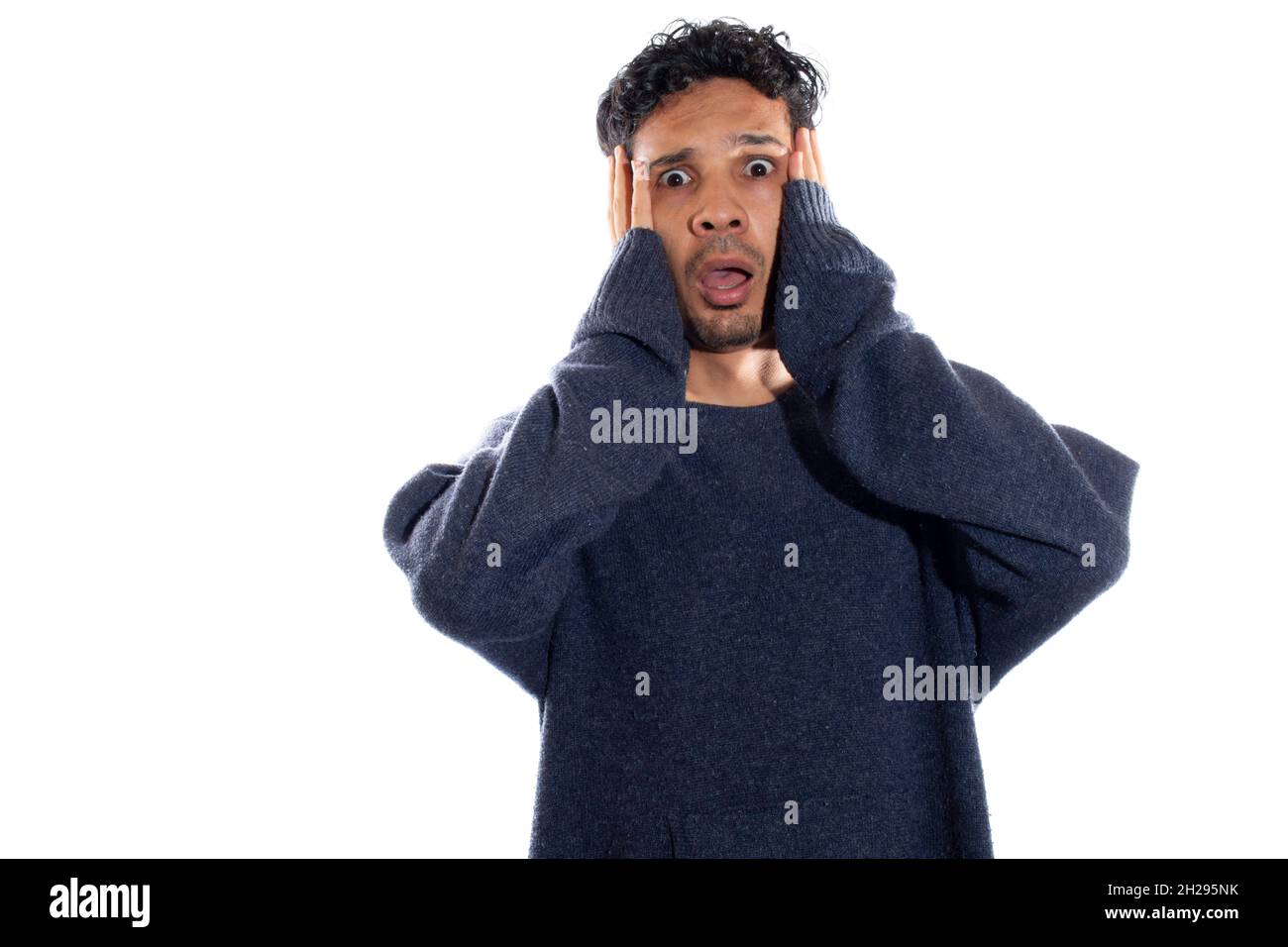 Young adult with a surprised or frightened face. Isolated on white ...