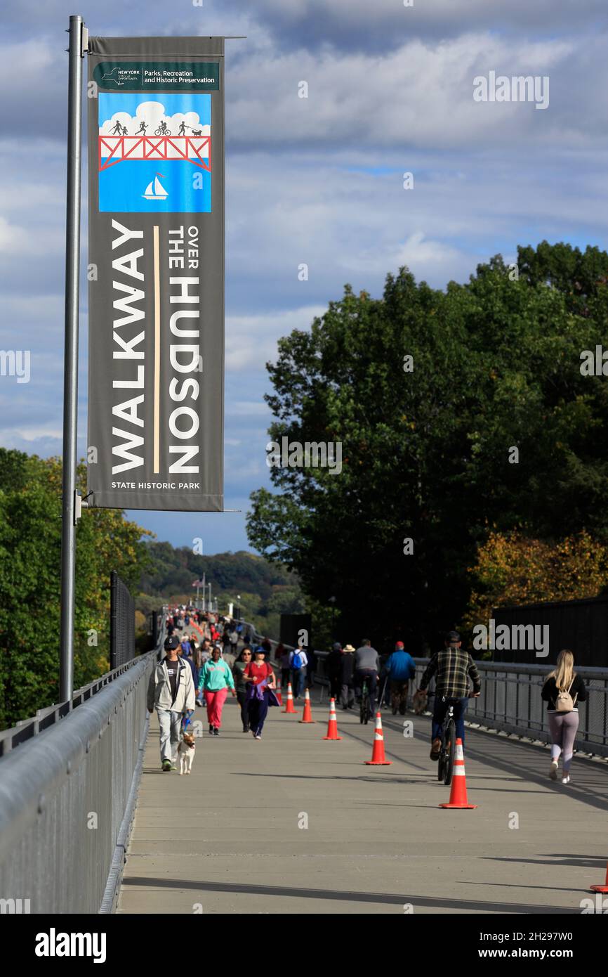 Visitors walking by the banners of "Walkway over the Hudson" decorating ...