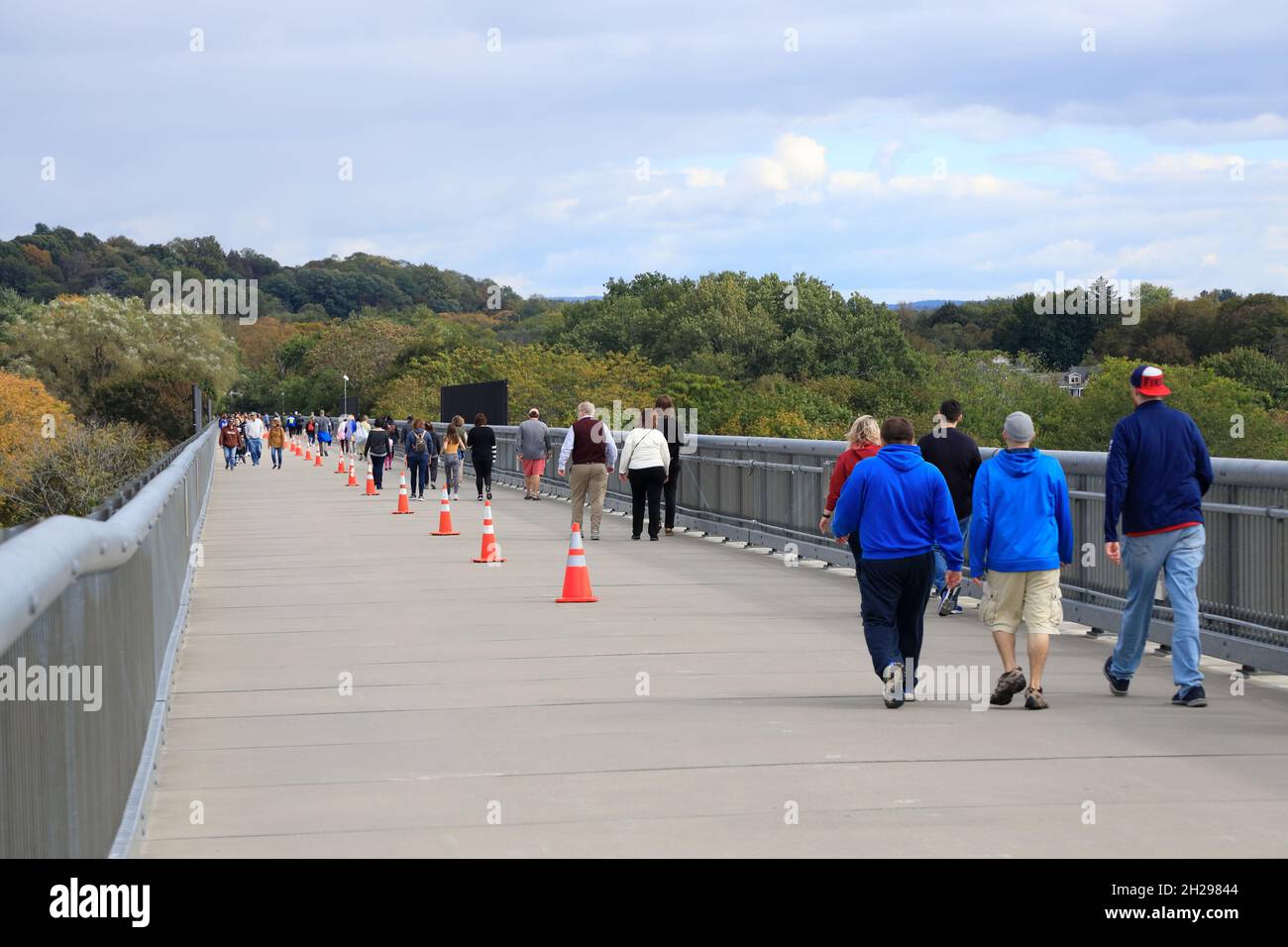 Visitors walking on Walkway Over the Hudson footbridge with town of ...