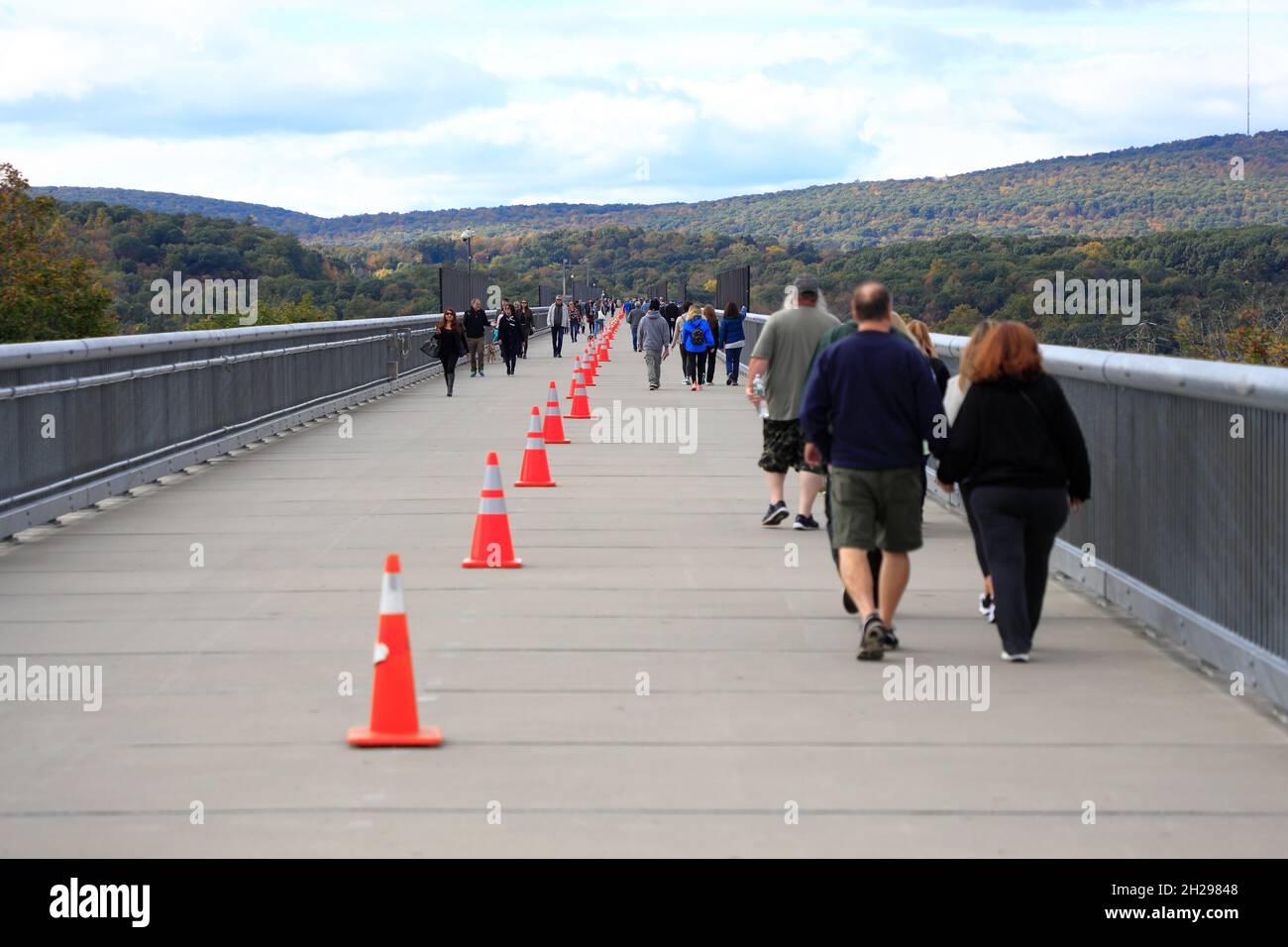 Visitors walking on Walkway Over the Hudson footbridge with town of ...