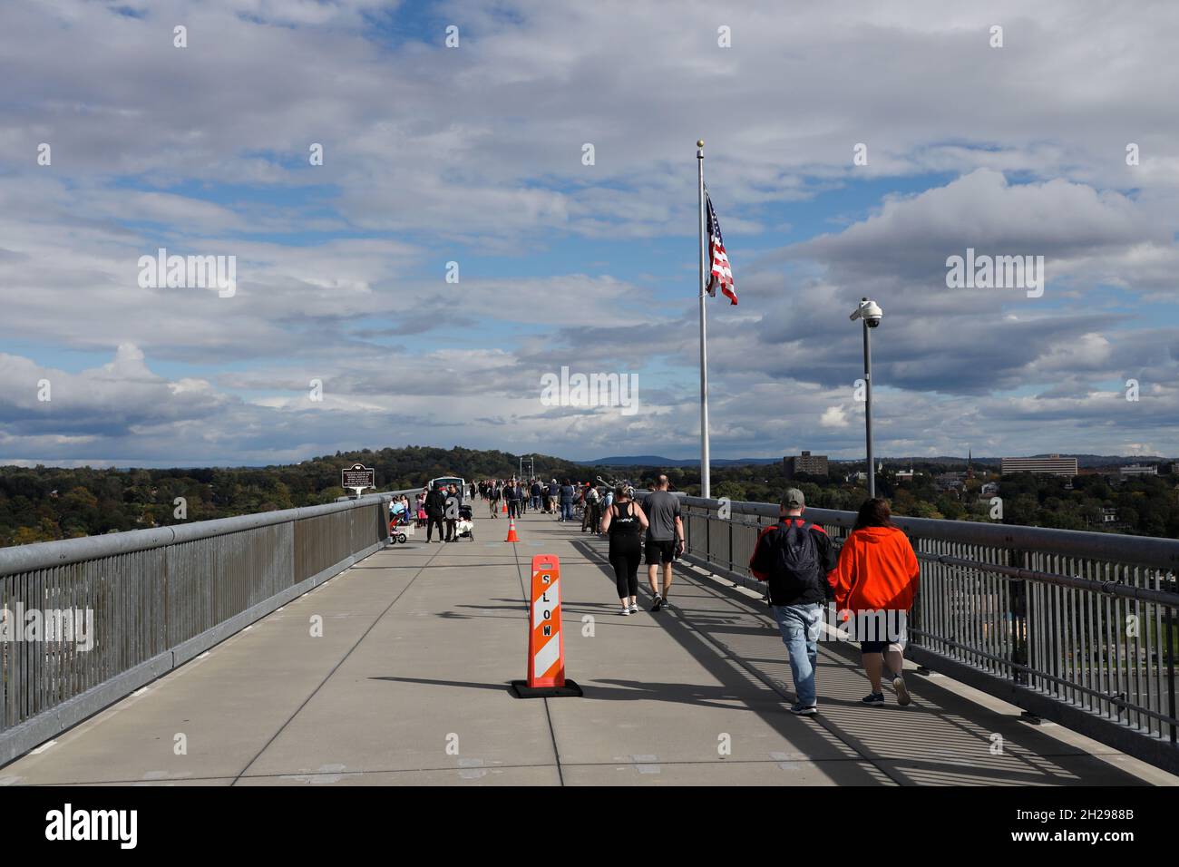 Visitors walking on Walkway Over the Hudson footbridge with town of ...