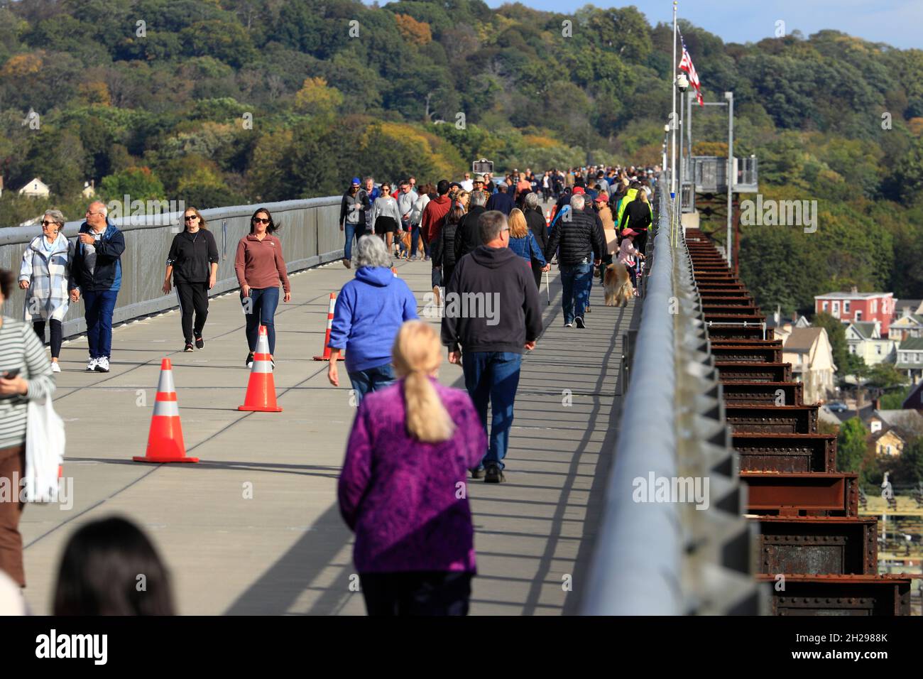 Visitors walking on Walkway Over the Hudson footbridge with town of ...