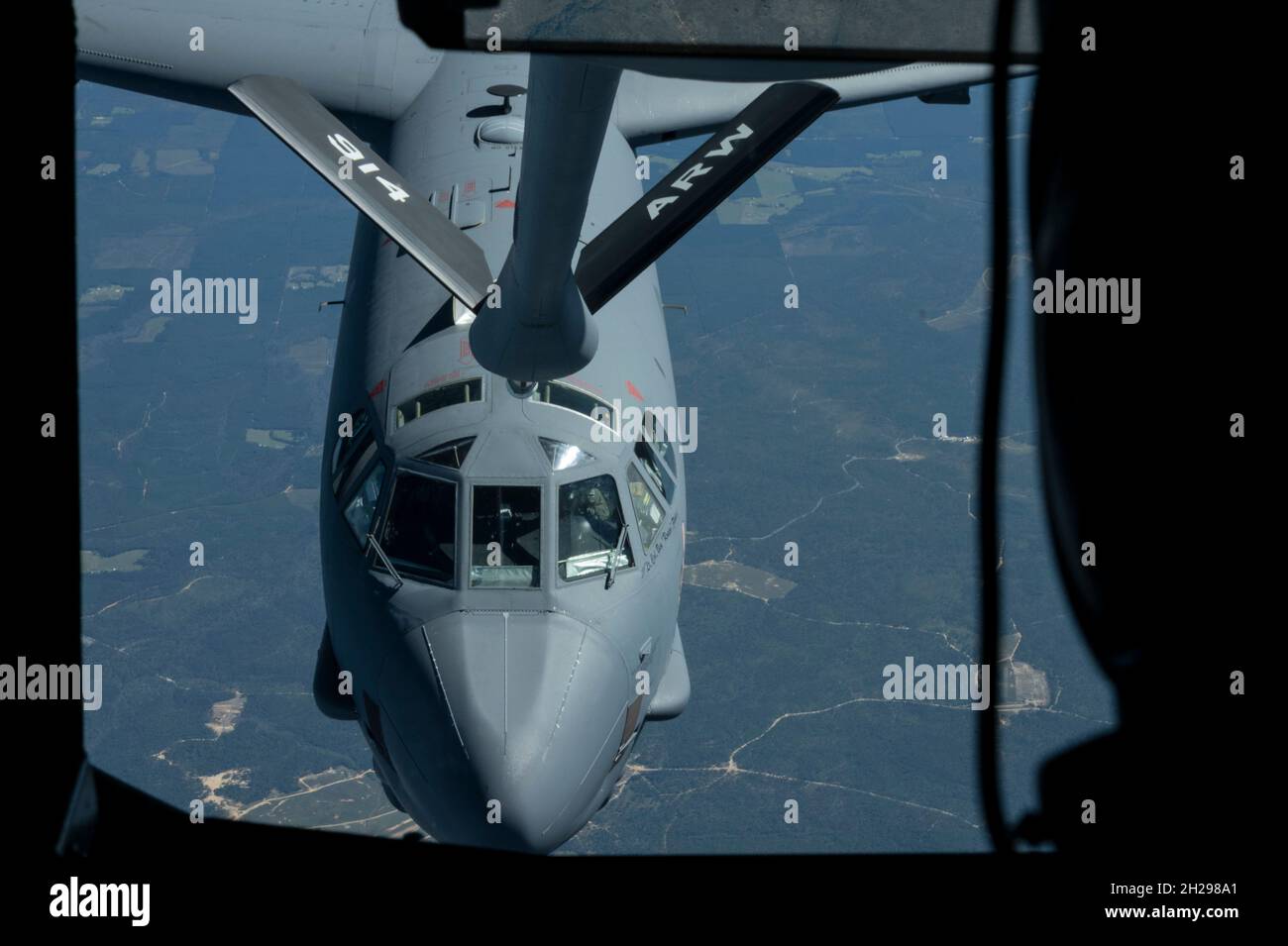 A 307th Bomb Wing B-52 Stratofortress flies below a 328th Air Refueling ...