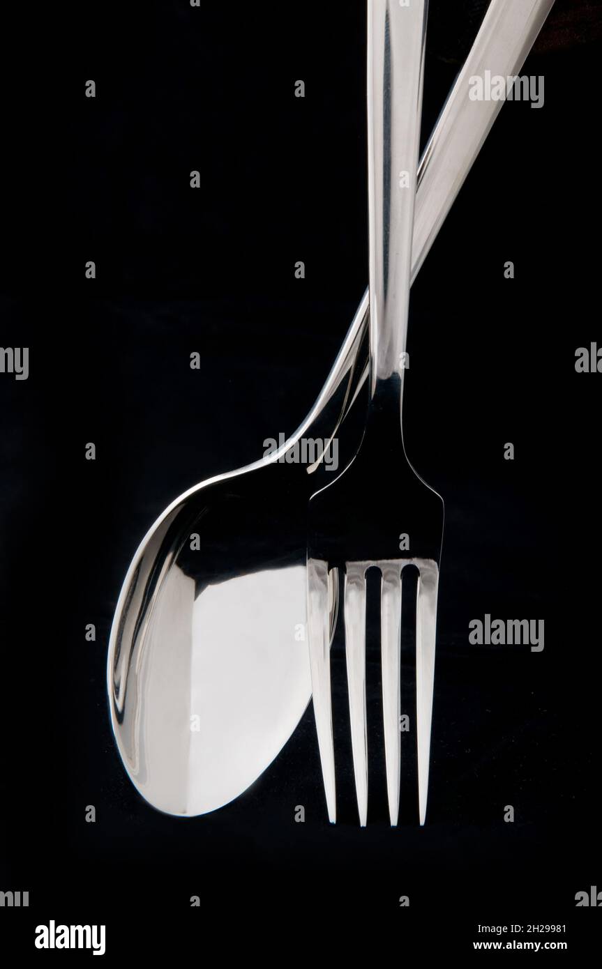 spoon and fork in black background Stock Photo - Alamy