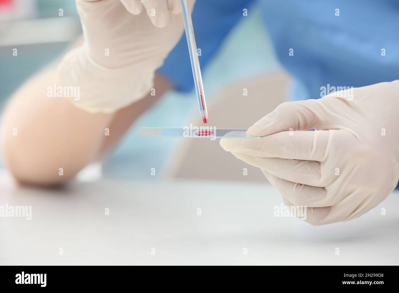 Scientist dripping blood sample on glass in laboratory Stock Photo - Alamy