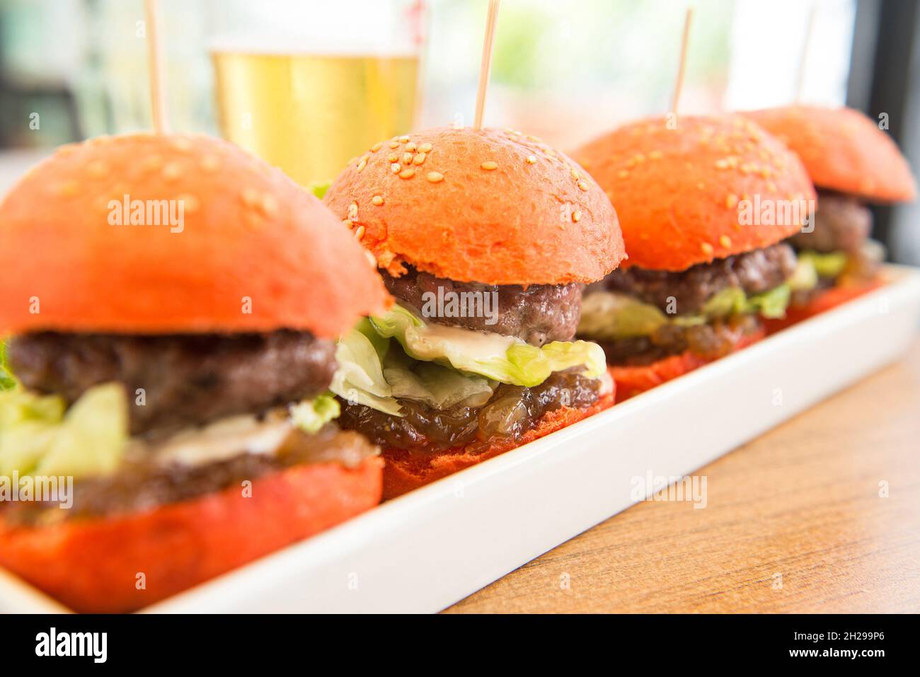 small hamburgers on tomato bun Stock Photo - Alamy