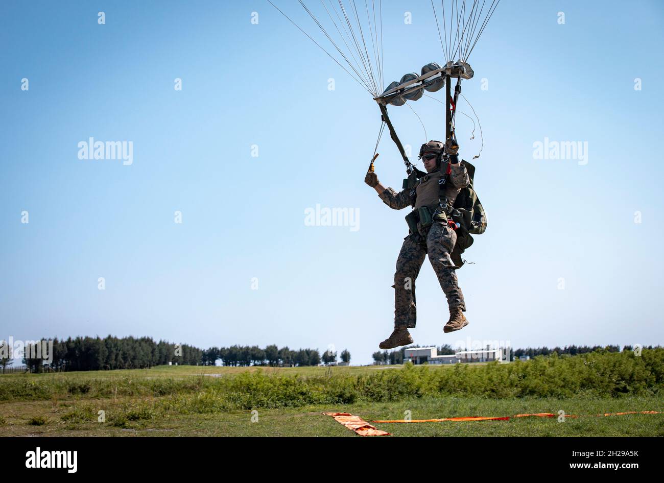 A U.S. Marine with the Force Reconnaissance Platoon lands on the drop ...