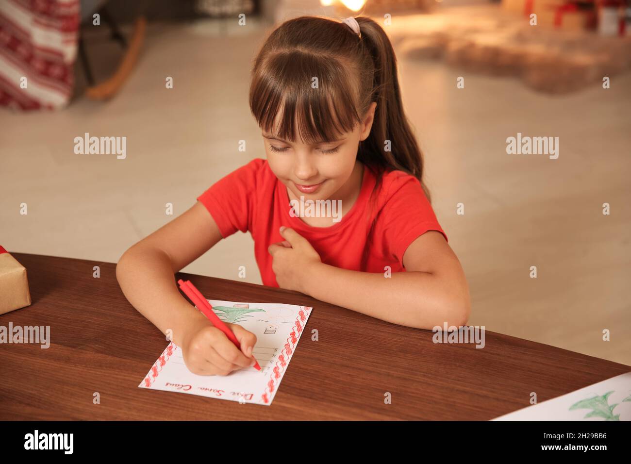 Little child writing letter to Santa at home. Christmas celebration ...