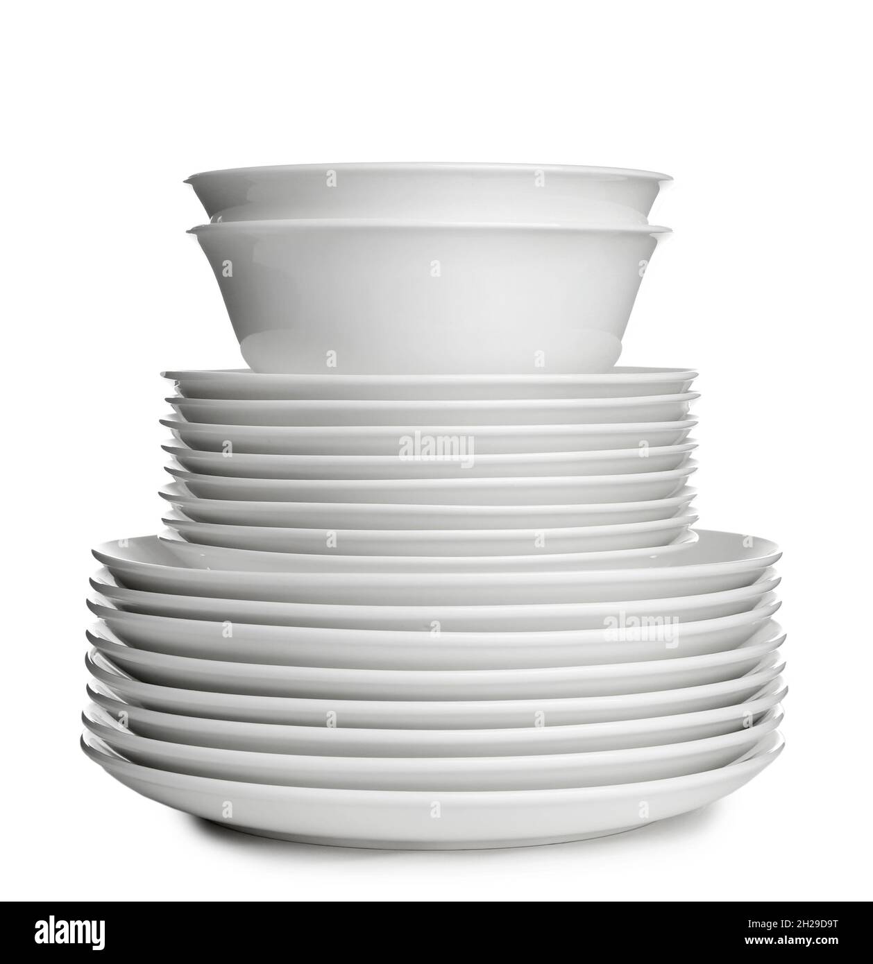 Stack of ceramic dishware on white background Stock Photo - Alamy